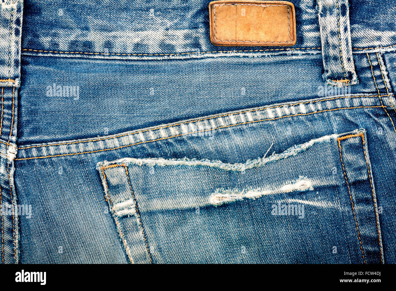 Blue jeans fabric with back pocket and a label background Stock Photo ...
