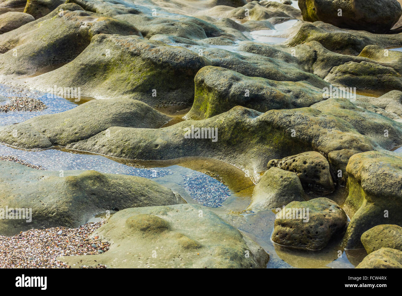 Wave sculpted rocks on this popular south Nicoya Peninsula surf beach ...