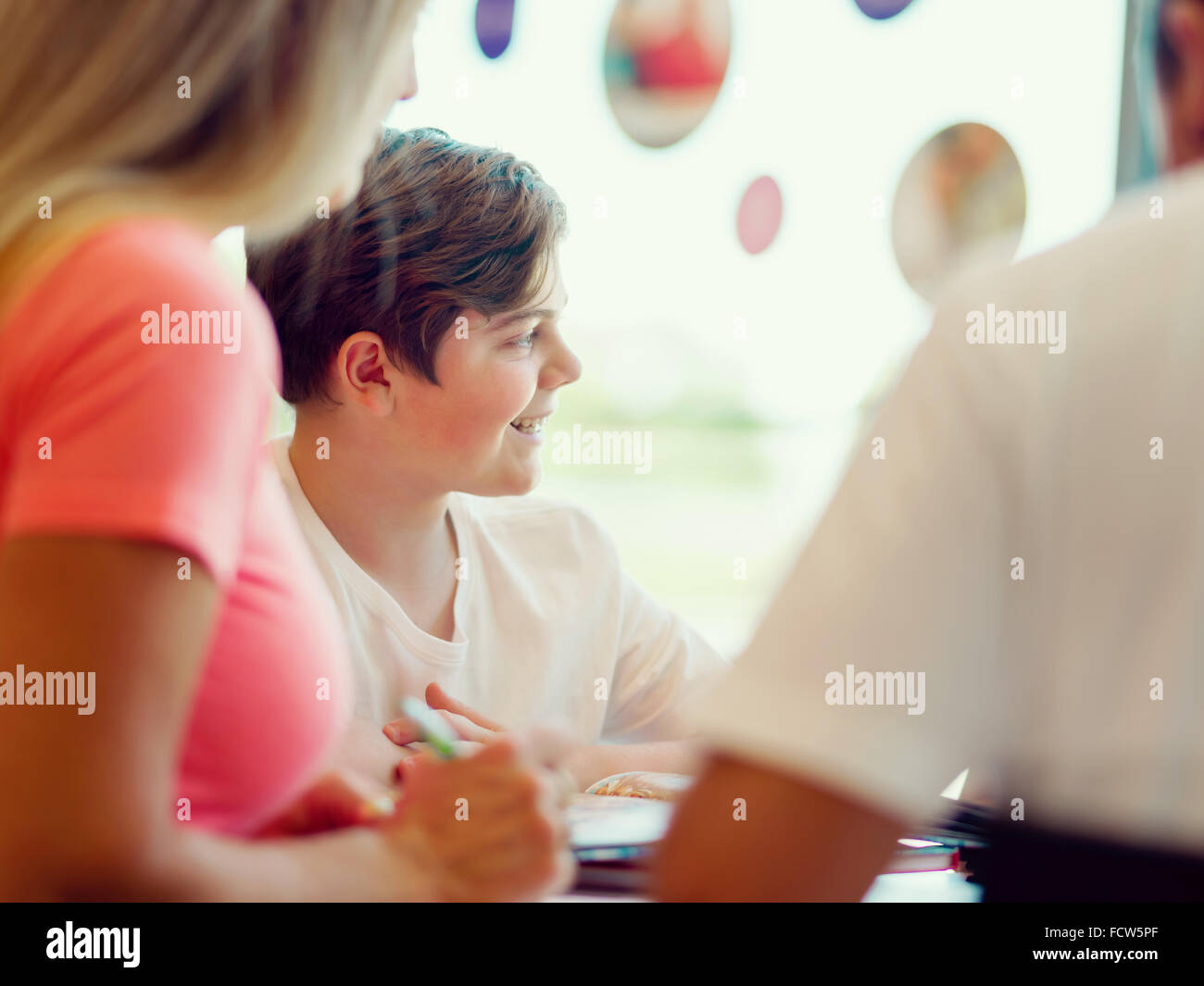 Family in library with books Stock Photo - Alamy