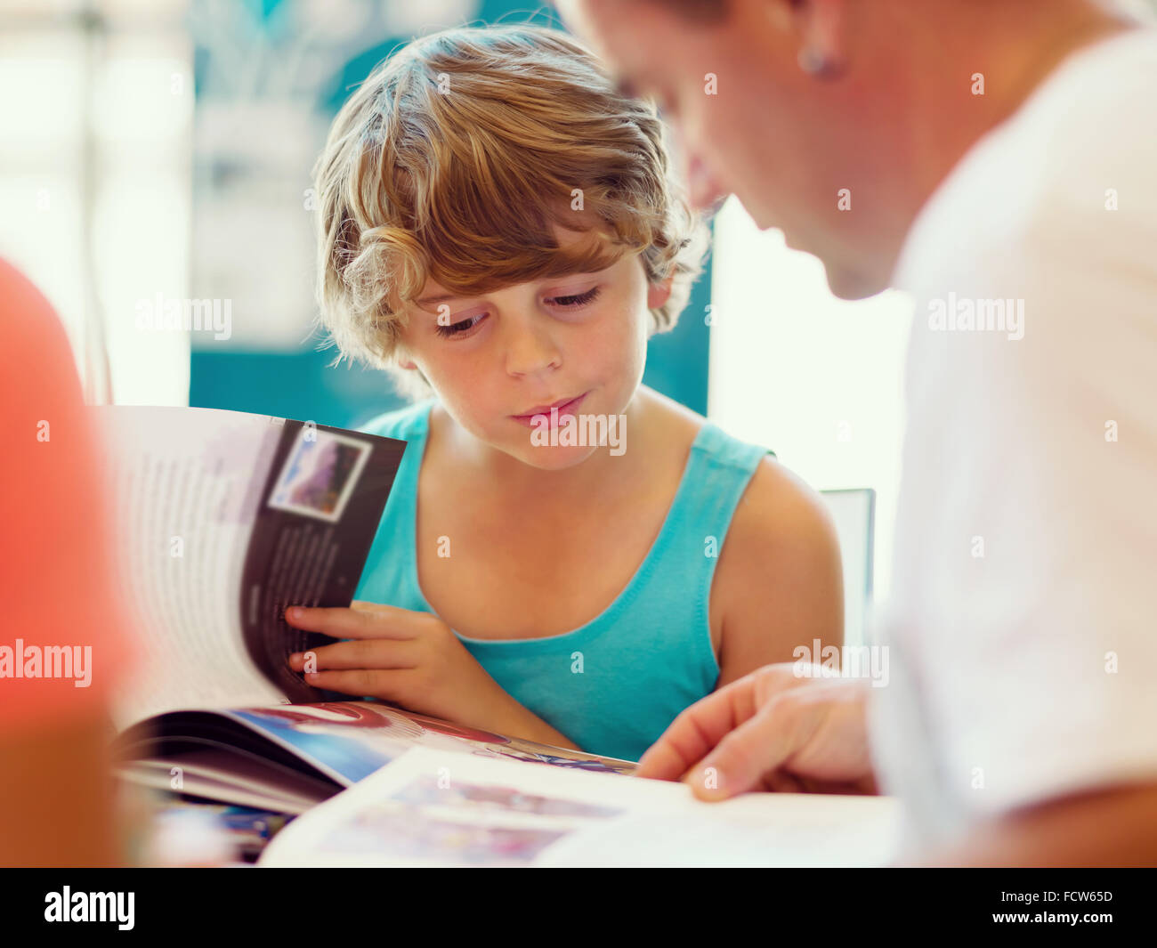 Family in library with books Stock Photo - Alamy