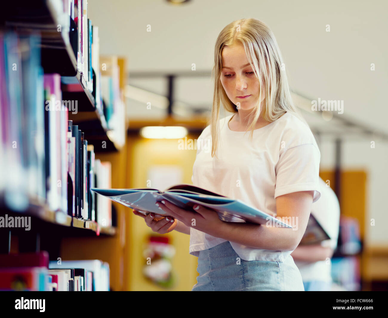 teenage girl in library choosing books Stock Photo - Alamy