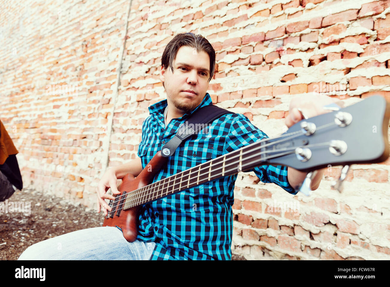 A street musician tuning his instrument Stock Photo - Alamy