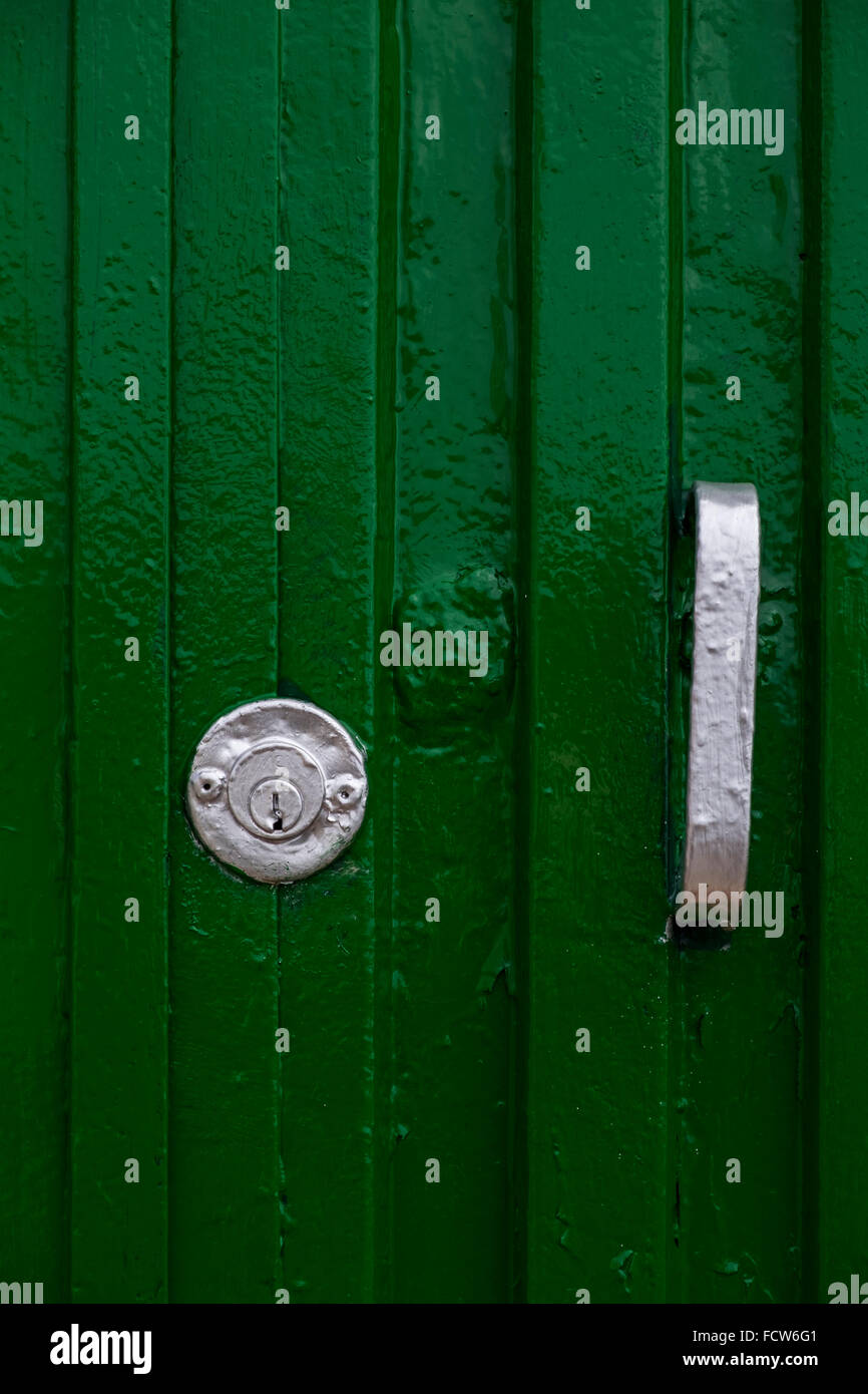 Freshly painted green metal door with silver handle and keyhole Stock ...
