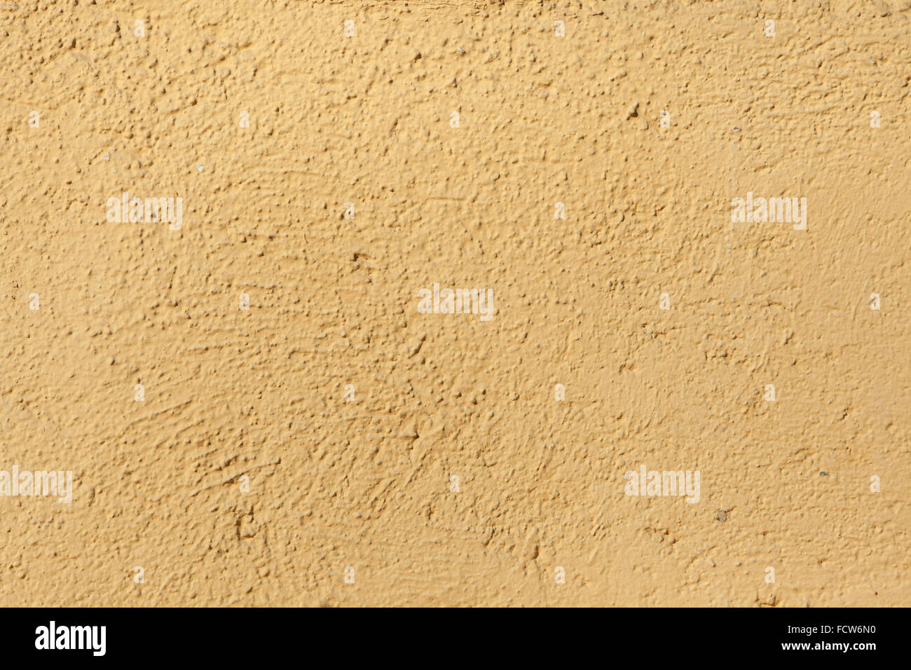 Yellow stucco wall. Background texture Stock Photo - Alamy