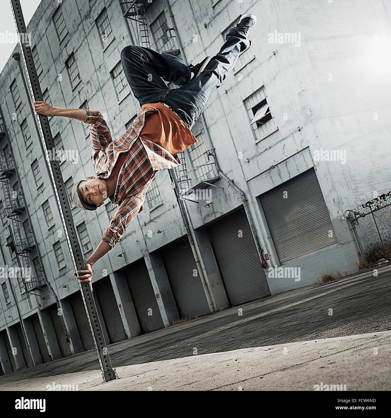 A young man breakdancing, leaping in the air, and stretching out Stock ...