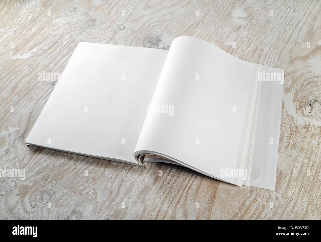 Bank opened book on light wooden background with soft shadows. Mock-up ...