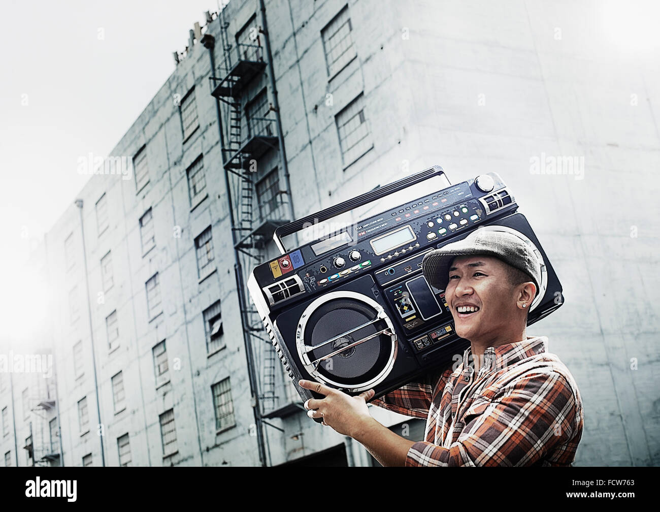 A young person with a boombox on the street of a city Stock Photo - Alamy