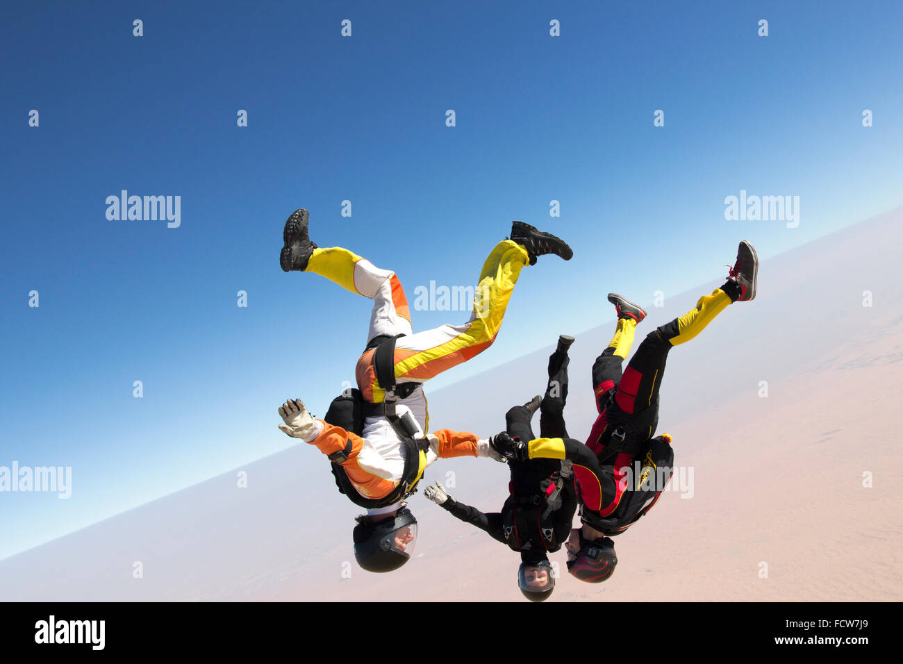 Freefly skydiving team is head-over flying in the blue sky together ...
