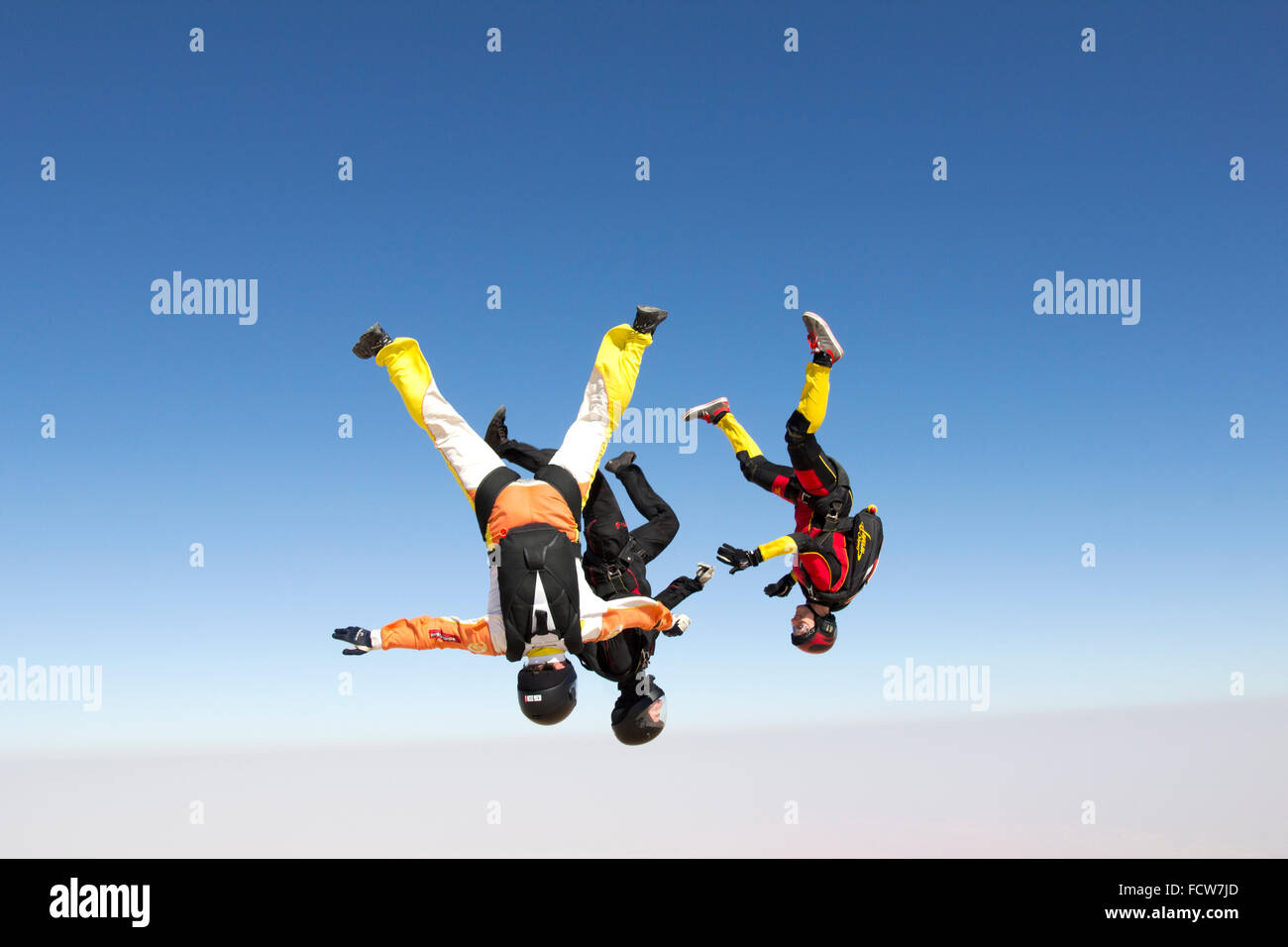 Freefly skydiving team is head-over flying in the blue sky together ...