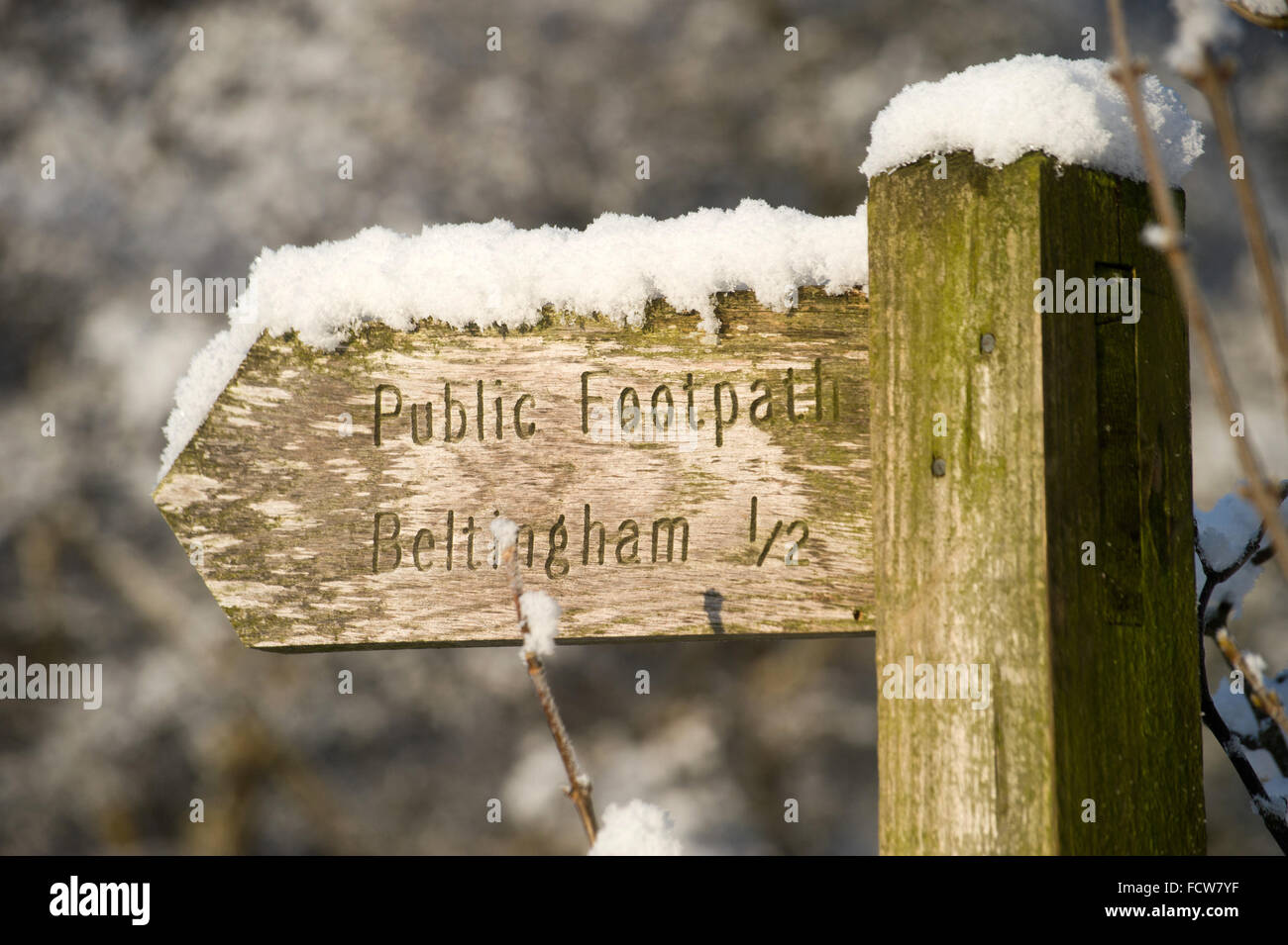Snow covered sign to Beltingham, Northumberland Stock Photo - Alamy