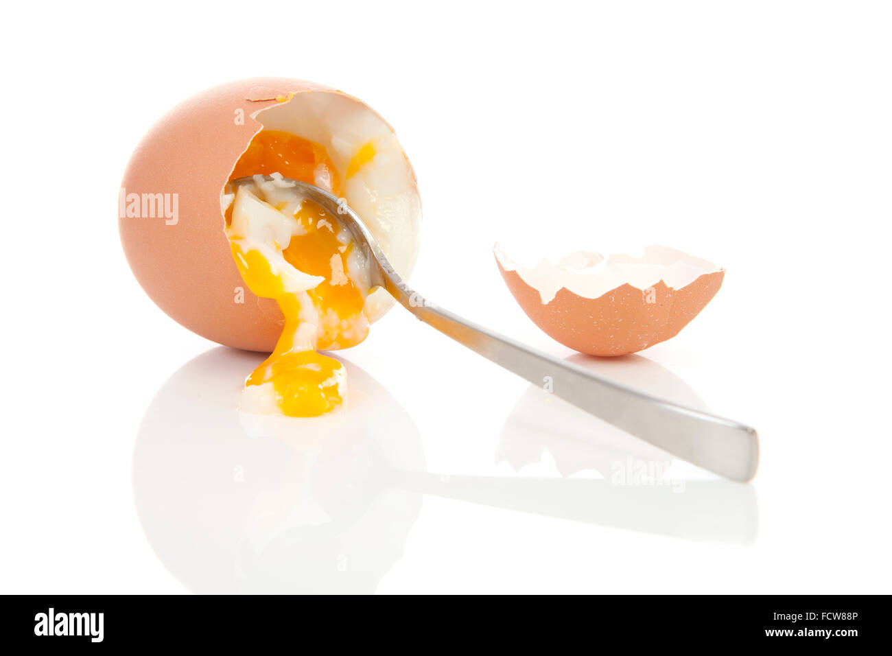 Boiled egg falling down over white background Stock Photo - Alamy
