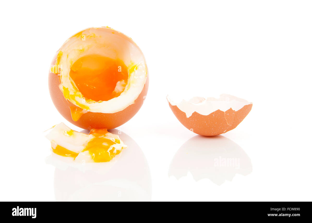 Boiled egg falling down over white background Stock Photo - Alamy