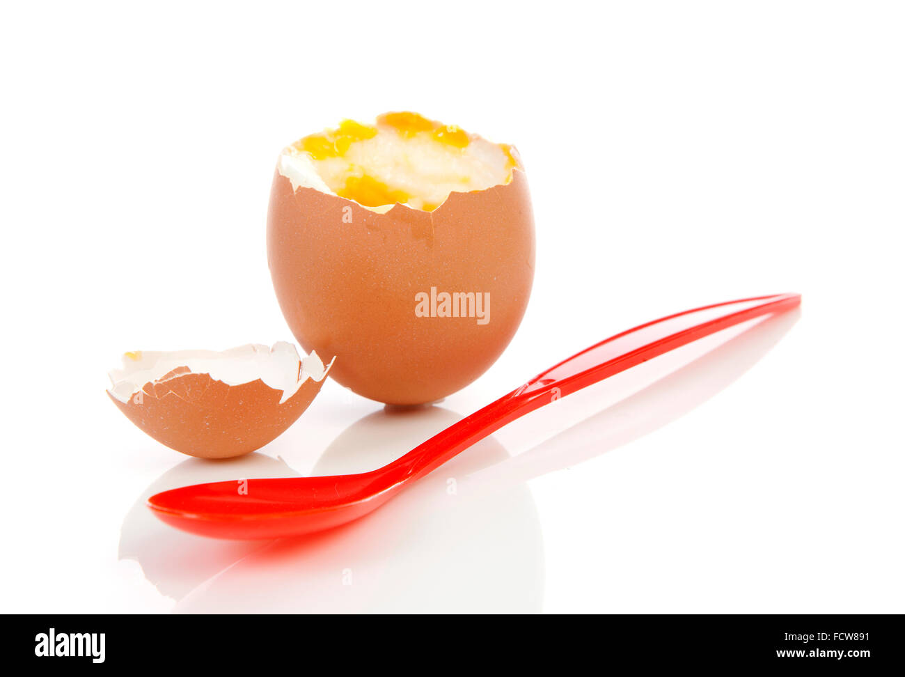 Boiled egg with red spoon over white bacvkground Stock Photo - Alamy