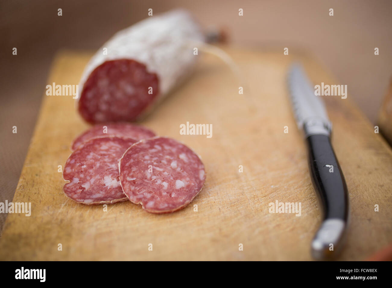 Italian salami and knife Stock Photo - Alamy