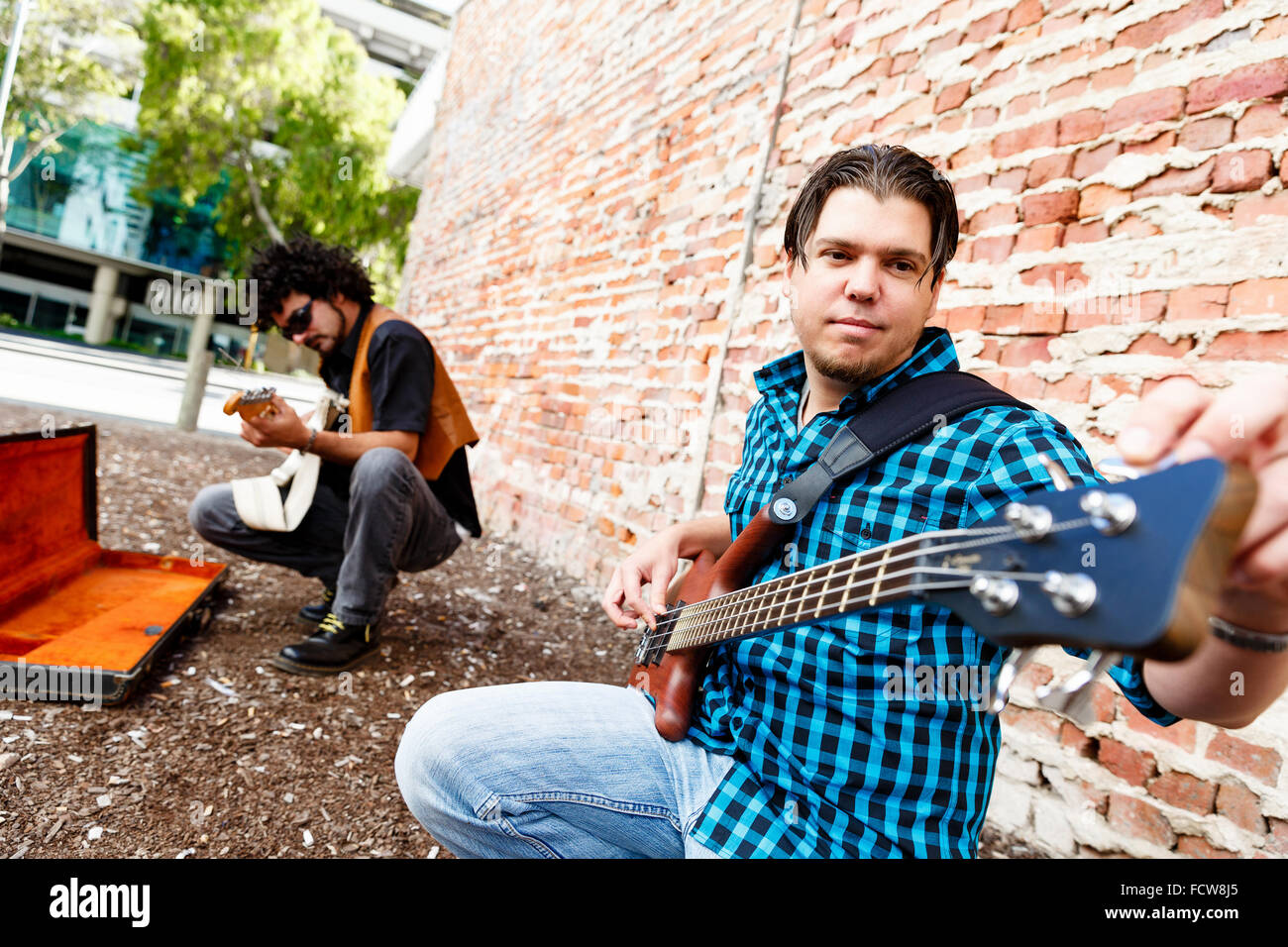 A street musician tuning his instrument Stock Photo - Alamy