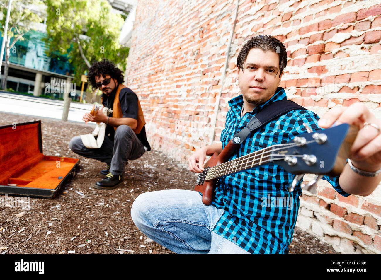 A street musician tuning his instrument Stock Photo - Alamy
