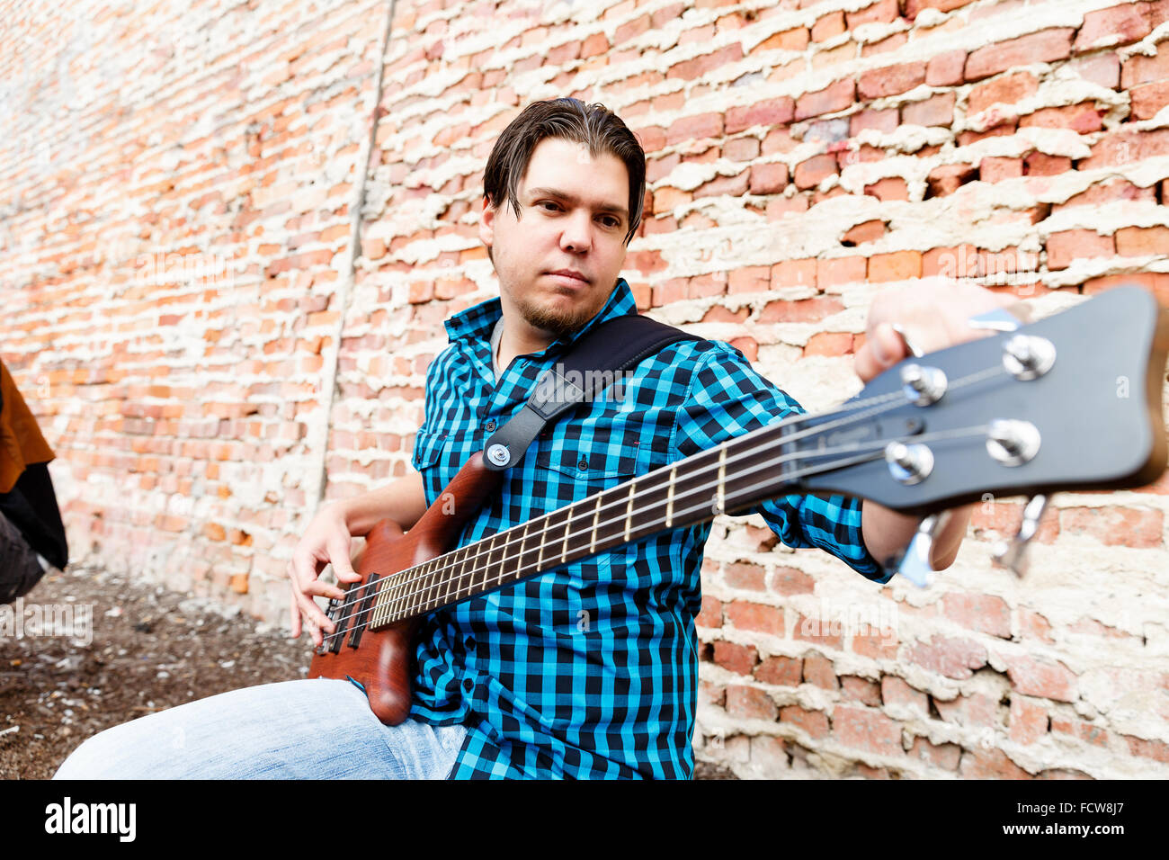 A street musician tuning his instrument Stock Photo - Alamy