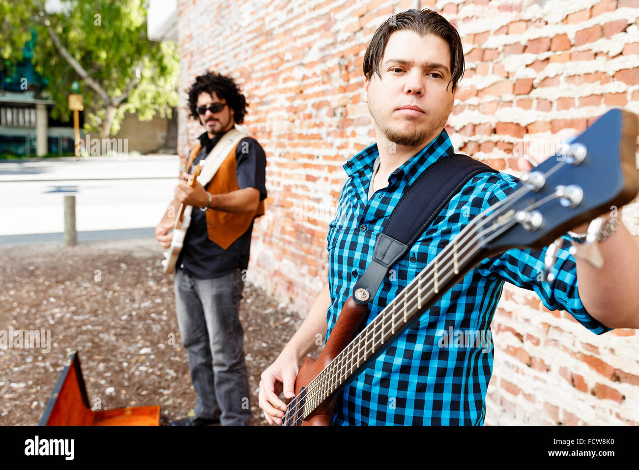 A street musician tuning his instrument Stock Photo - Alamy