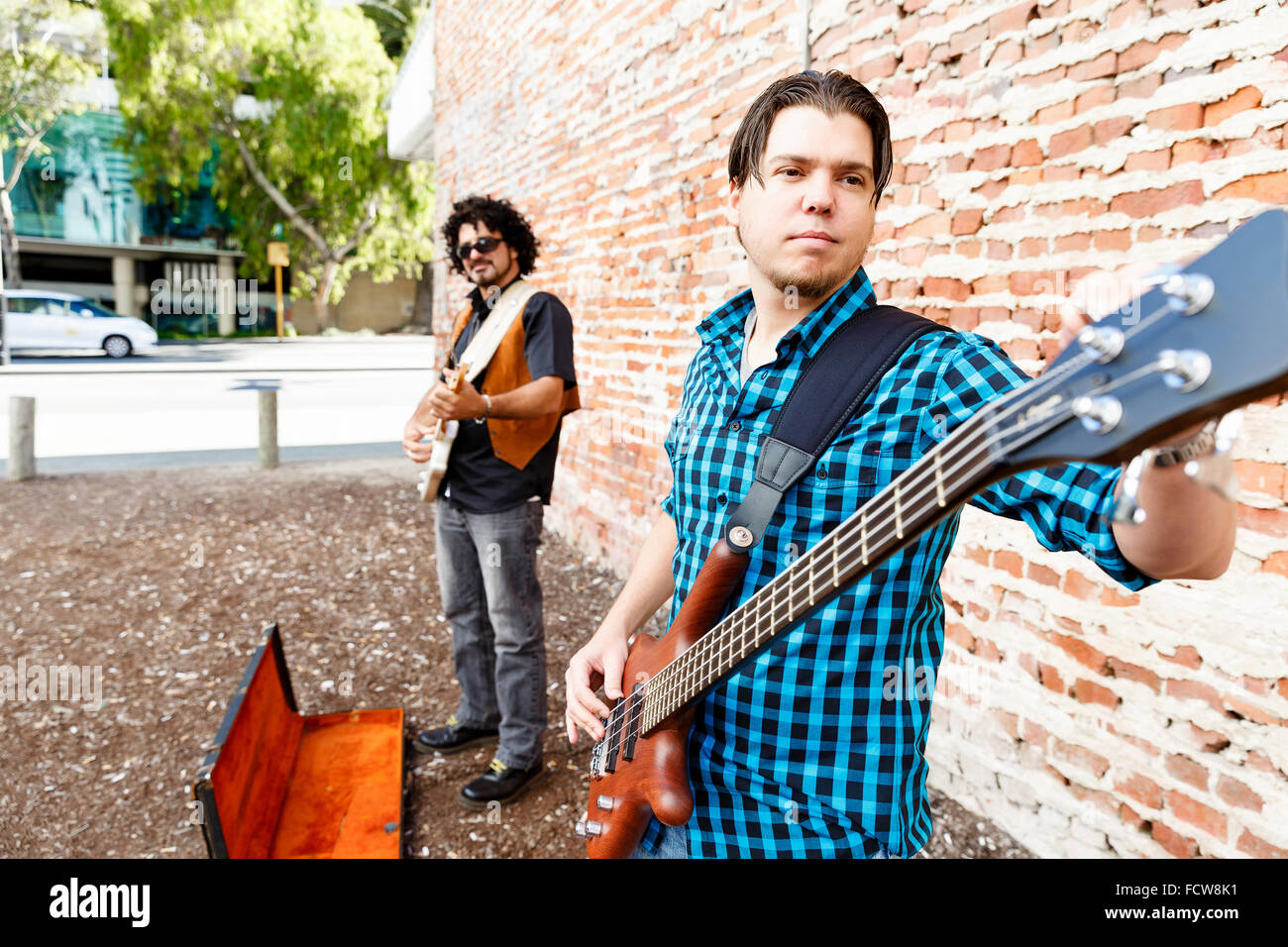 A street musician tuning his instrument Stock Photo - Alamy