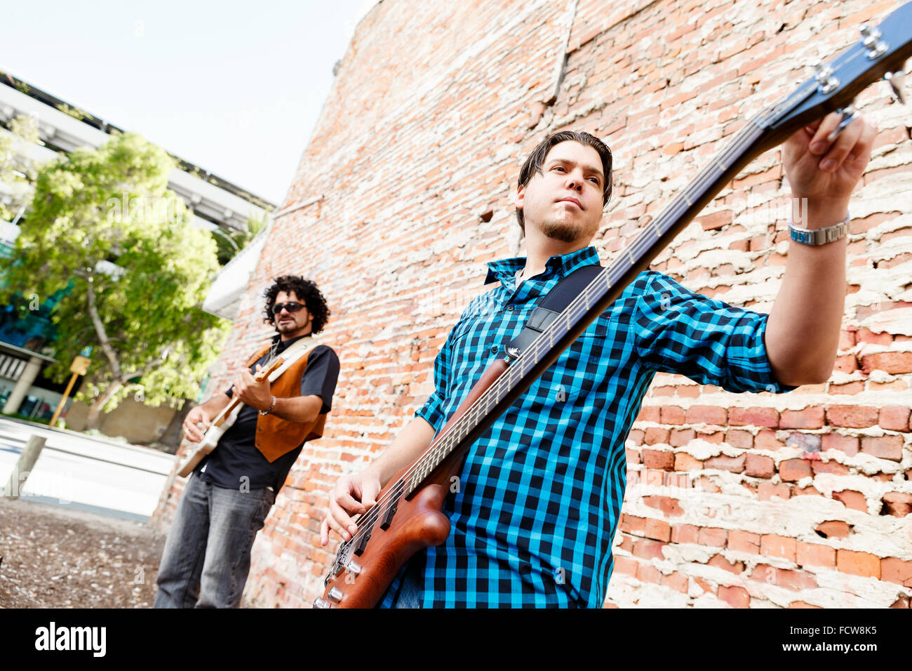 A street musician tuning his instrument Stock Photo - Alamy