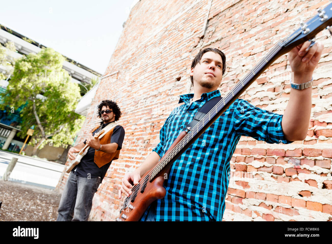 A street musician tuning his instrument Stock Photo - Alamy