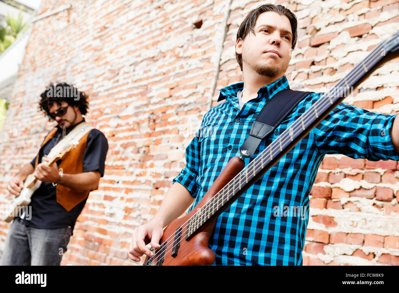 A street musician tuning his instrument Stock Photo - Alamy