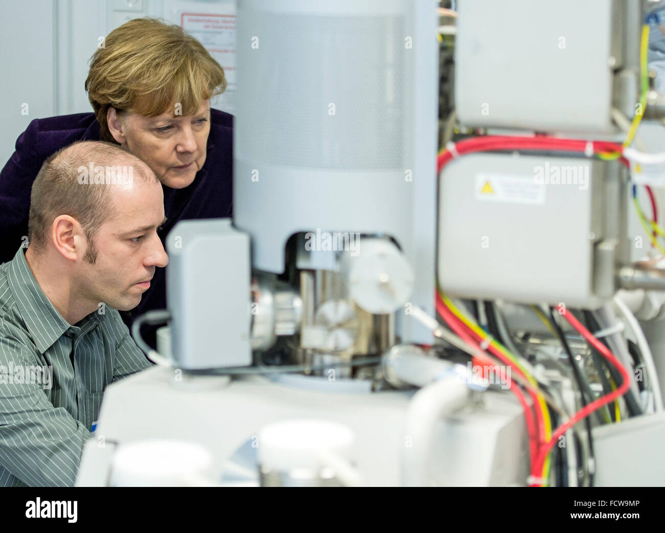 German chancellor Angela Merkel (2-L) looks around in one of the labs ...