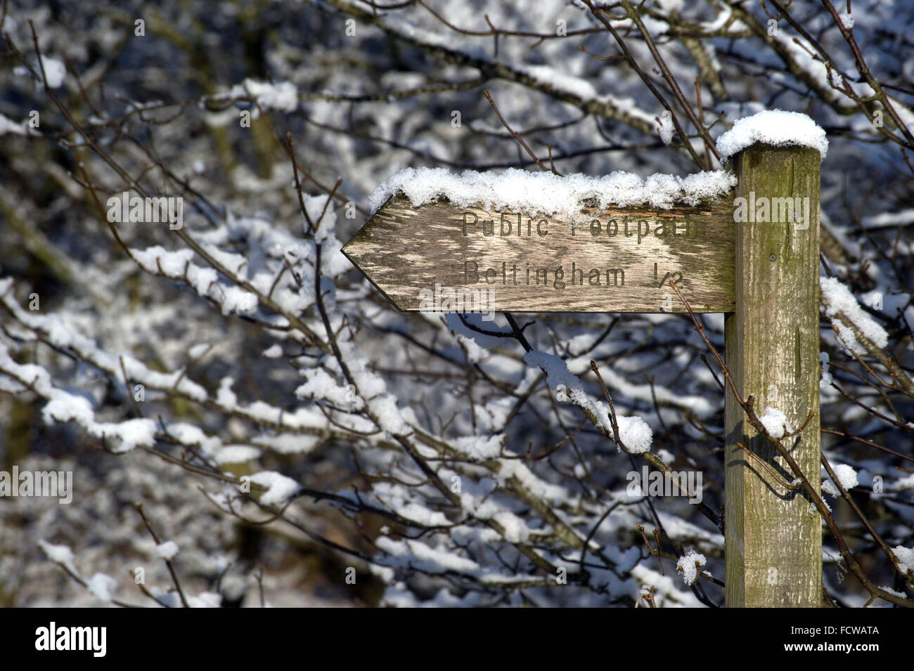 Snow covered sign to Beltingham, Northumberland Stock Photo - Alamy