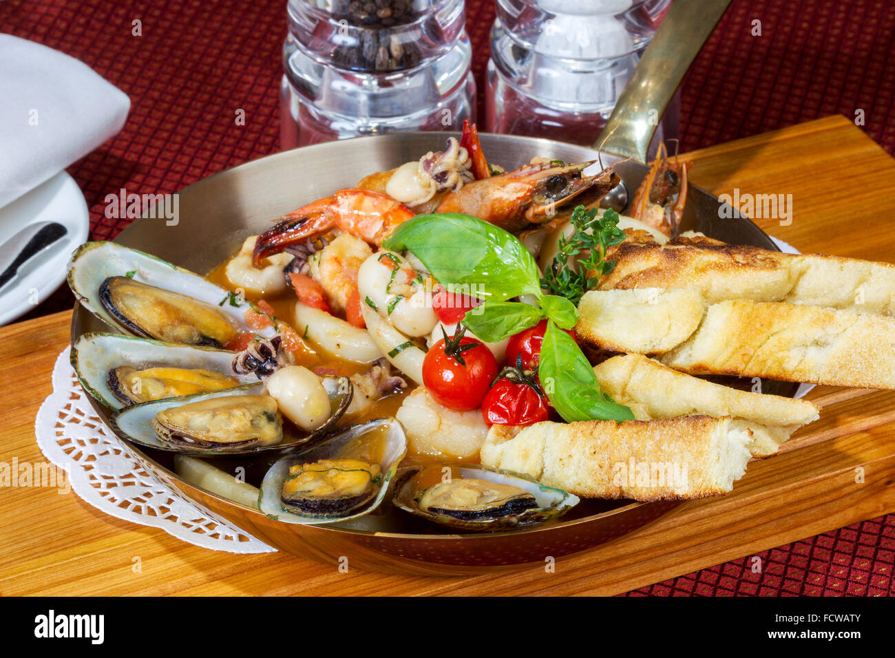 Seafood cocktail, calamari, mussels, shrimp in a pan on the serving ...