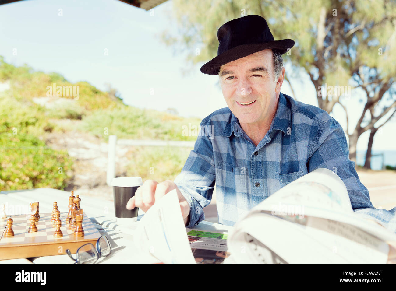 Senior gentleman reading newspaper in park Stock Photo - Alamy