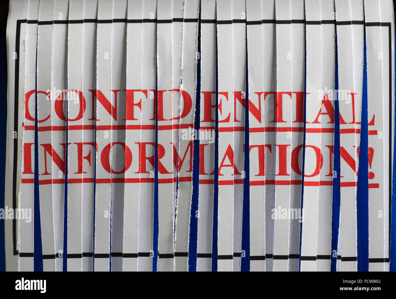 "CONFIDENTIAL INFORMATION" paper through a shredder Stock Photo - Alamy