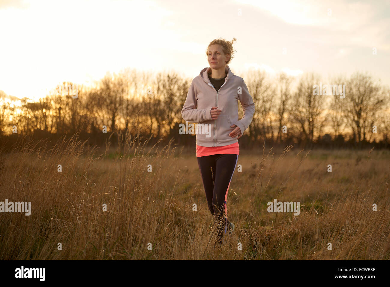 Woman running through field hi-res stock photography and images - Alamy