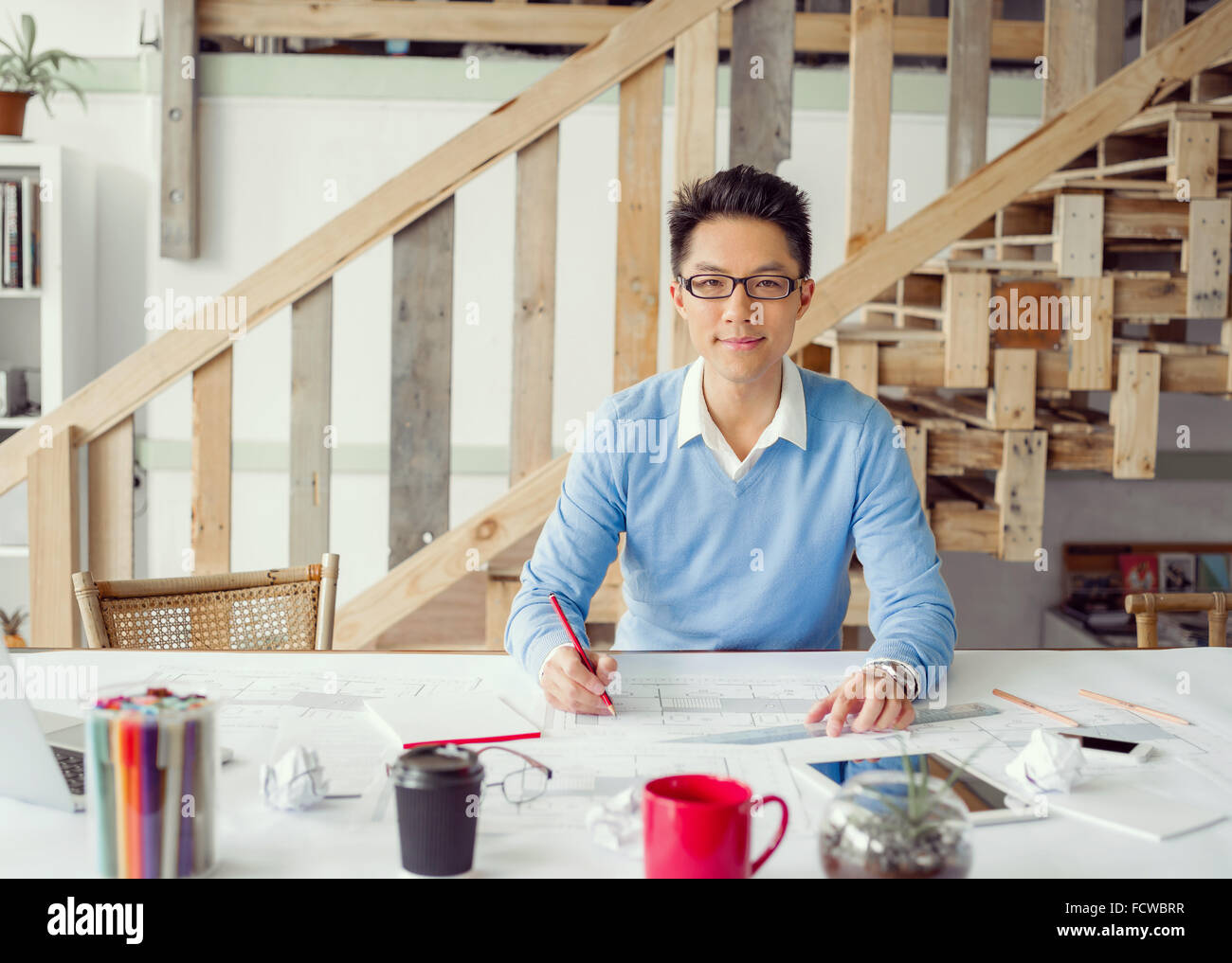 Young chineese engineer working in office Stock Photo - Alamy
