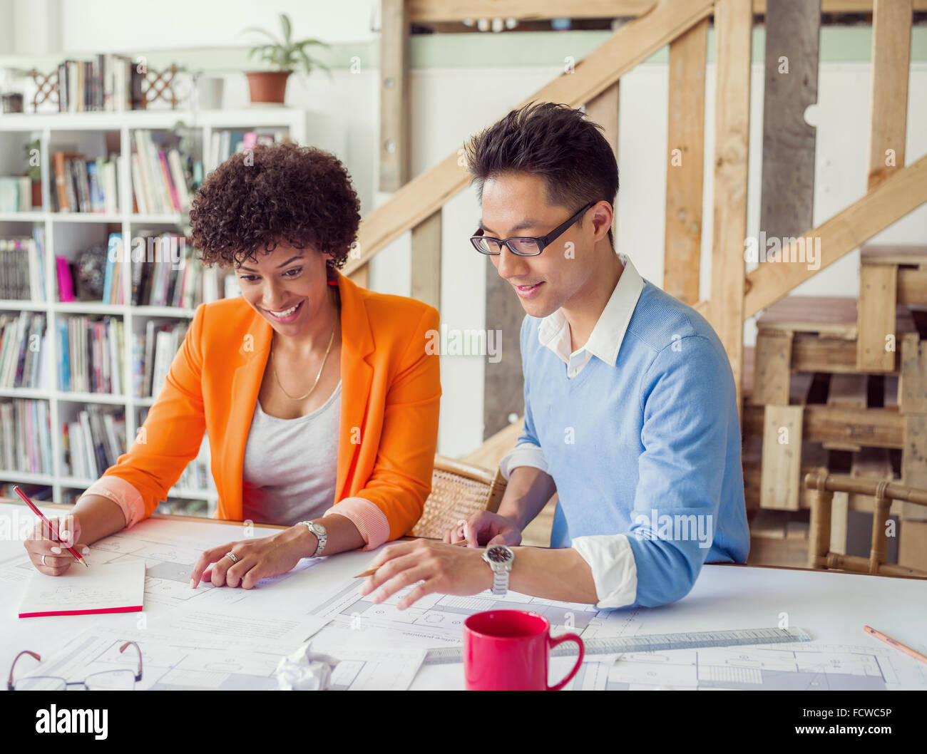 Two desingers working on a project together in office Stock Photo - Alamy