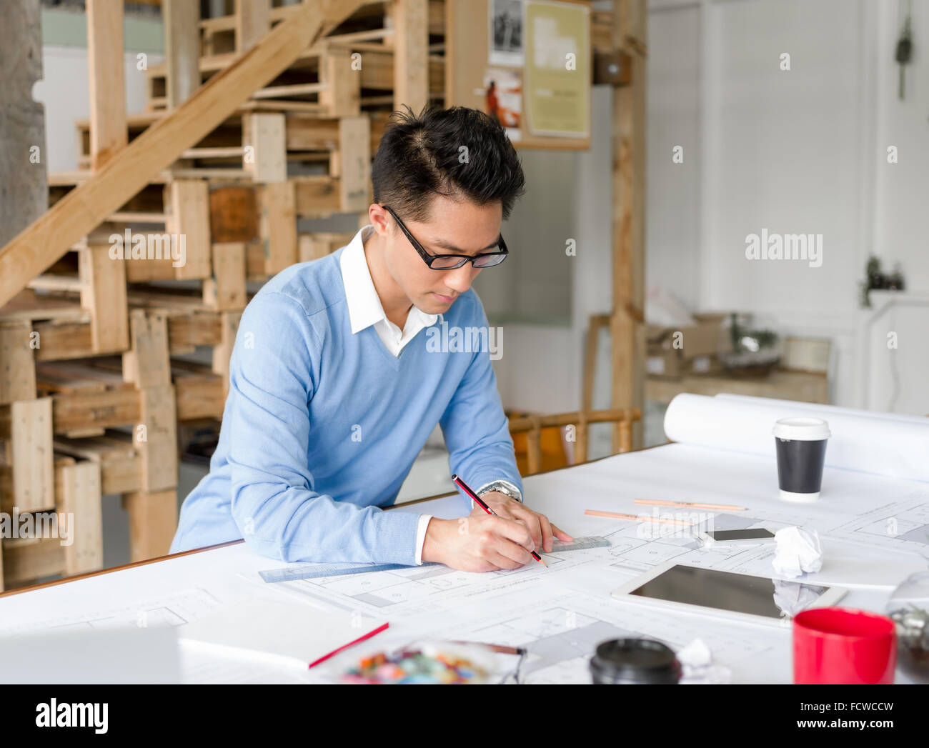 Young chineese engineer working in office Stock Photo - Alamy