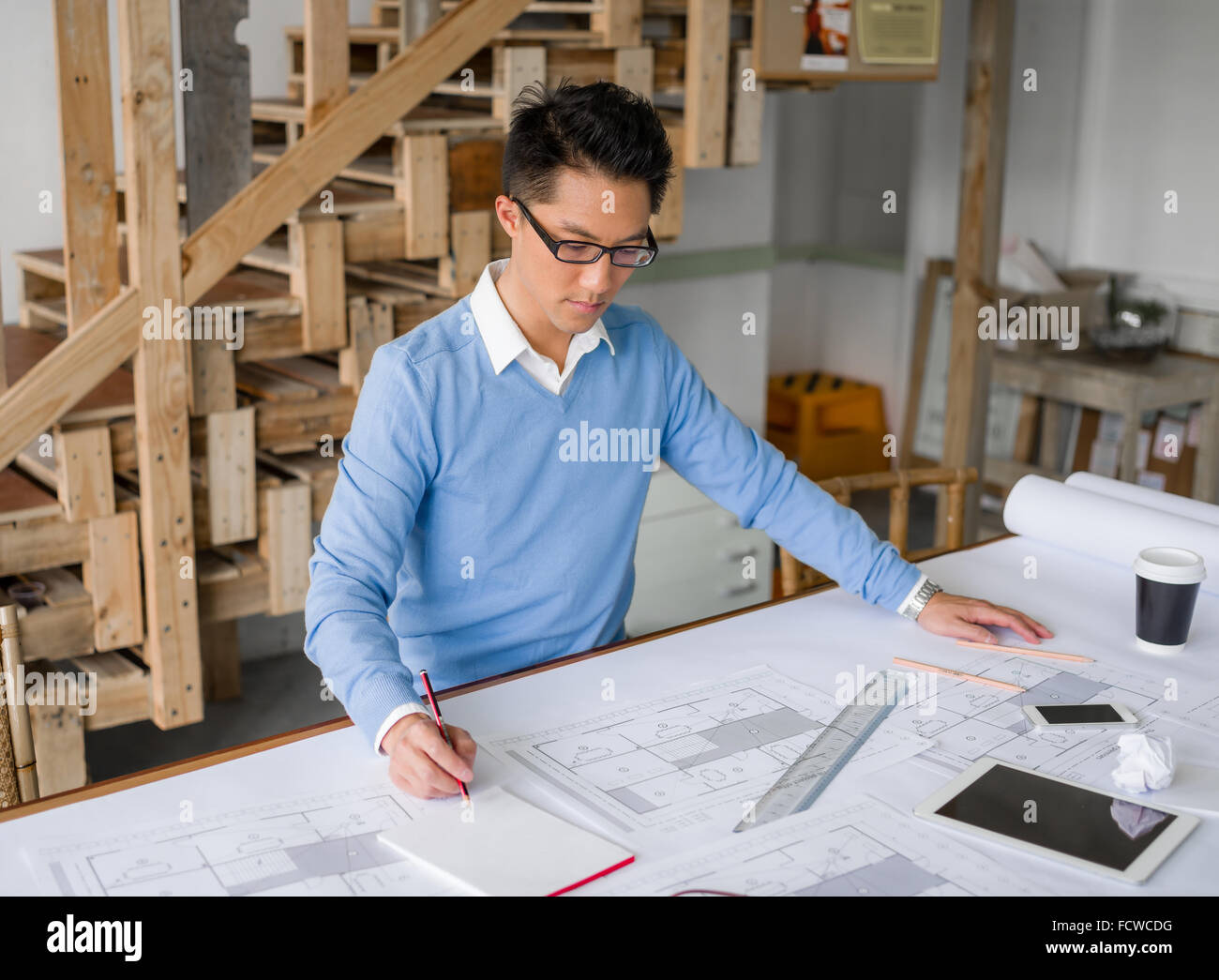 Young chineese engineer working in office Stock Photo - Alamy