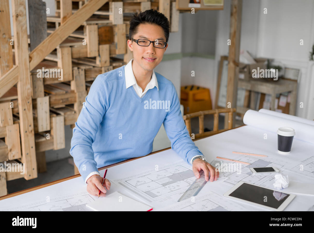 Young chineese engineer working in office Stock Photo - Alamy