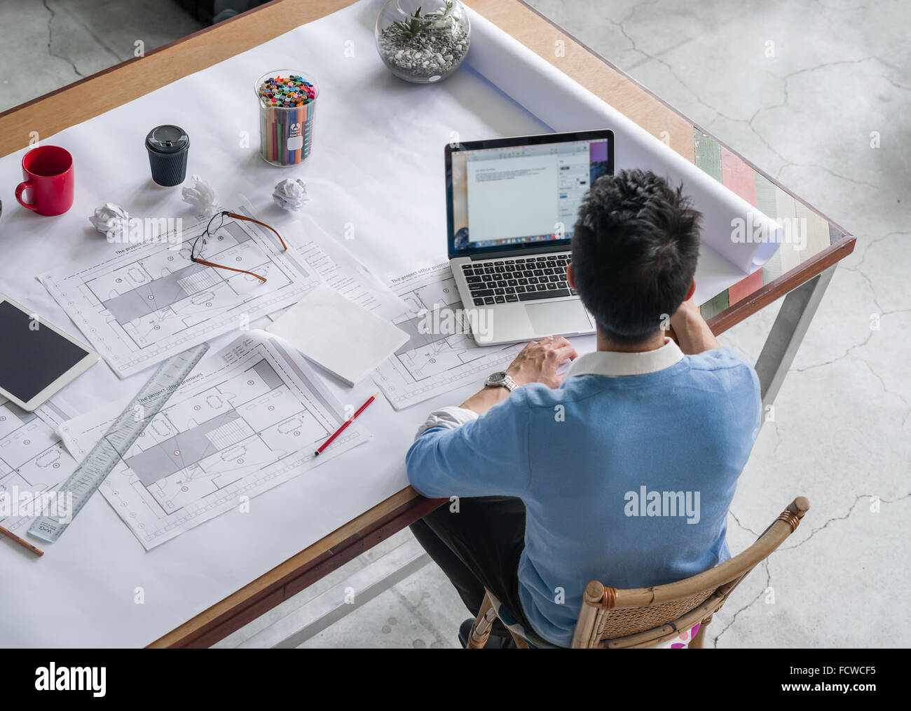 Young chineese engineer working in office Stock Photo - Alamy