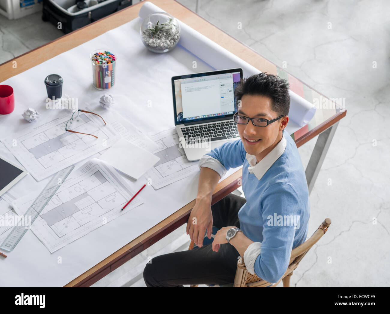 Young chineese engineer working in office Stock Photo - Alamy