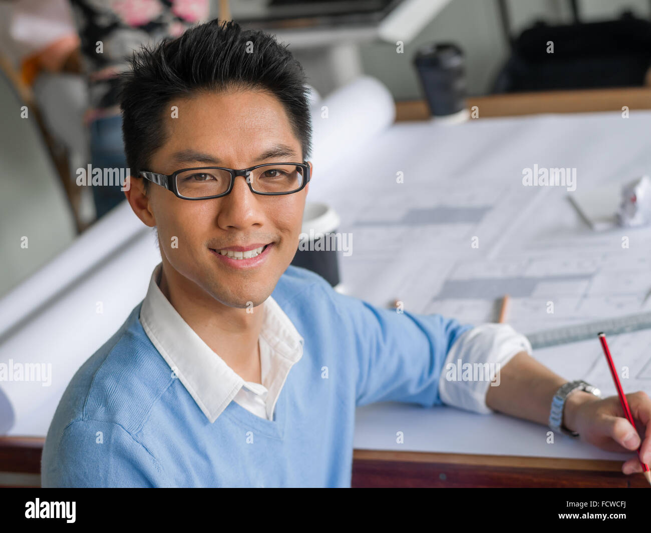 Young chineese engineer working in office Stock Photo - Alamy