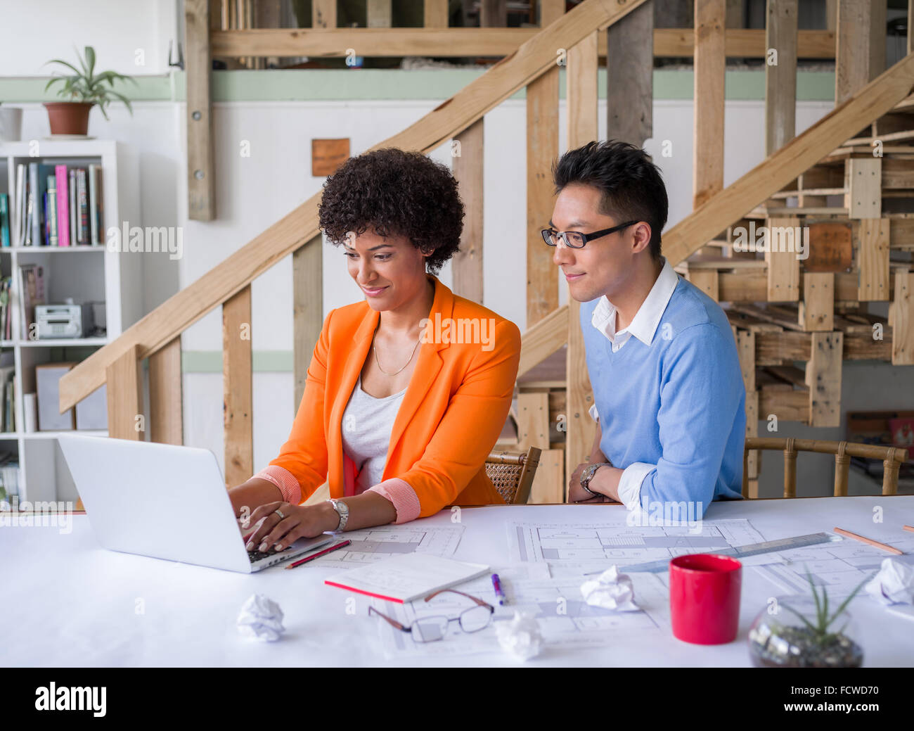 Two desingers working on a project together in office Stock Photo - Alamy