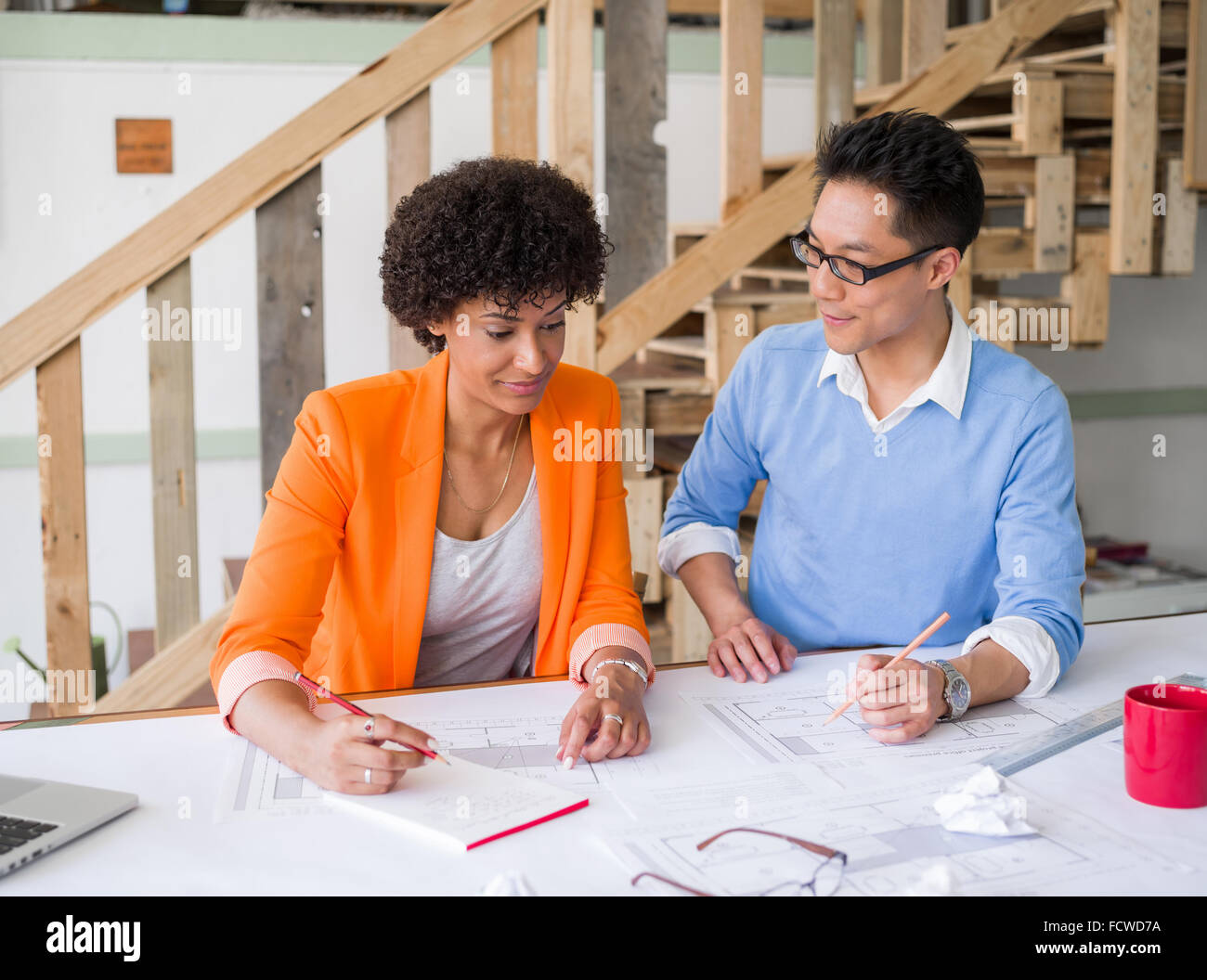 Two desingers working on a project together in office Stock Photo - Alamy