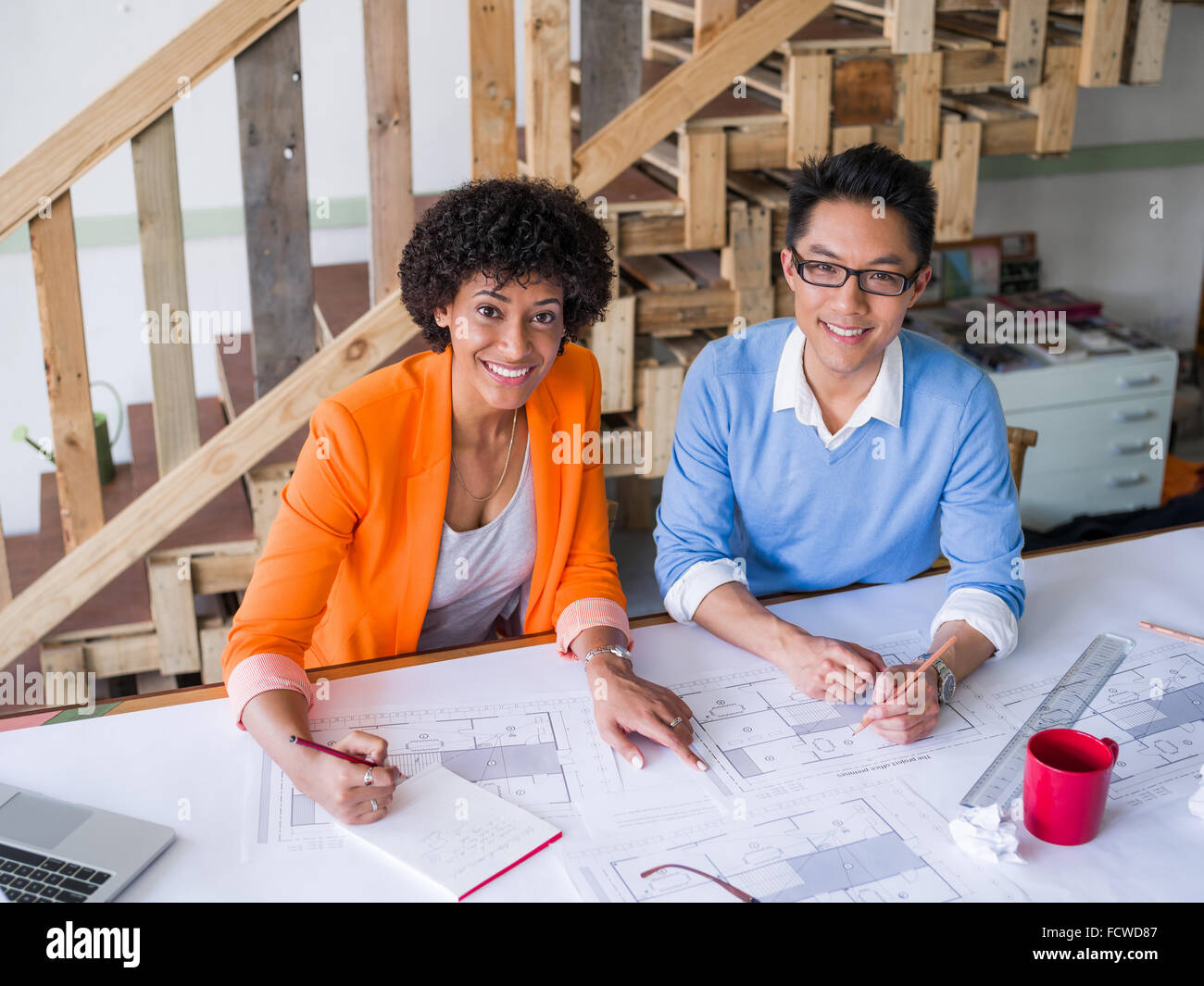 Two desingers working on a project together in office Stock Photo - Alamy