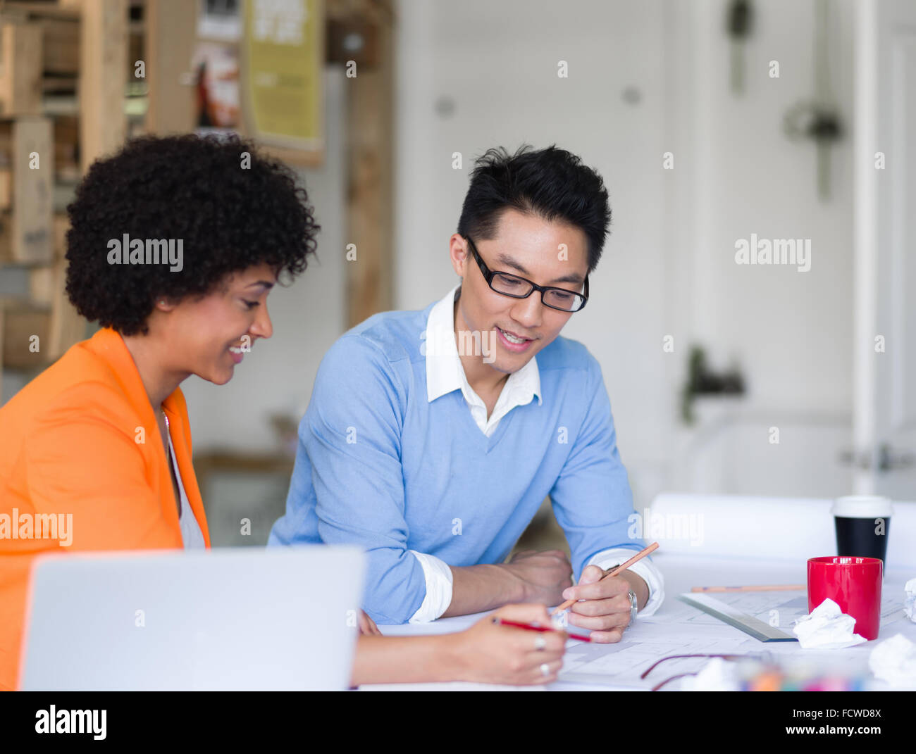 Two desingers working on a project together in office Stock Photo - Alamy