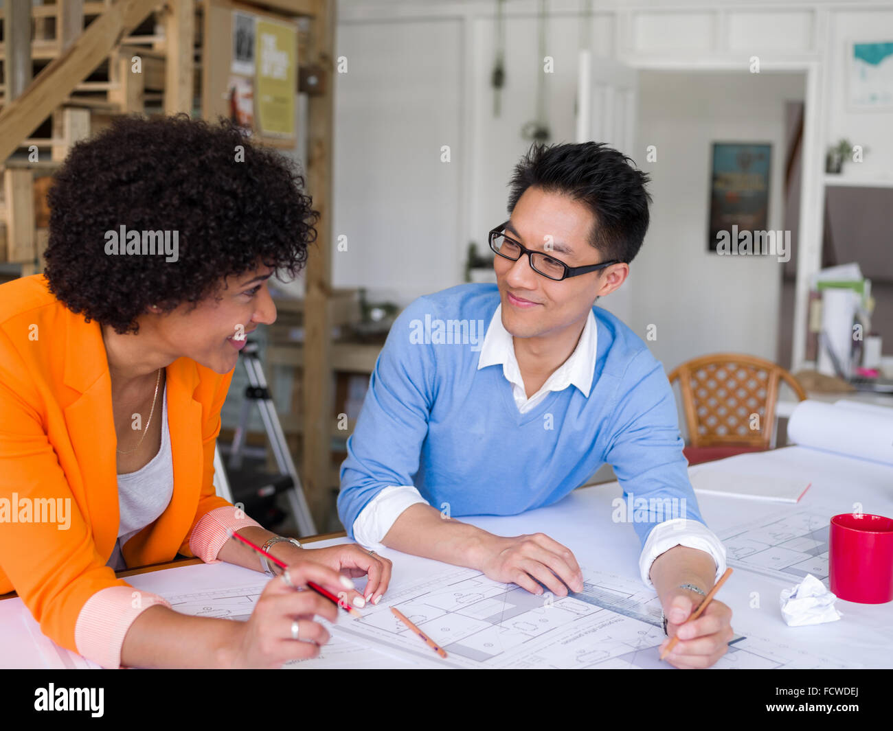 Two desingers working on a project together in office Stock Photo - Alamy