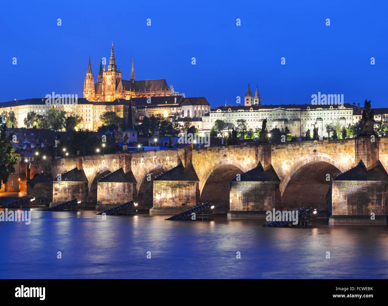 Vltava river, Charles Bridge and Prague Castle at night against a dark ...