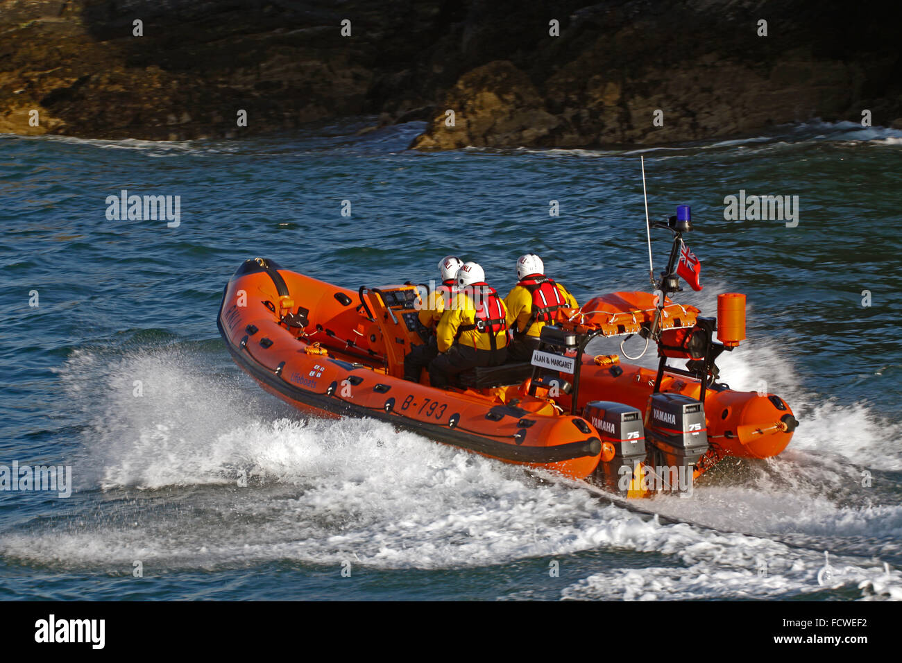 Looe RNLI's Atlantic 75 inshore lifeboat in Looe river heading out into ...