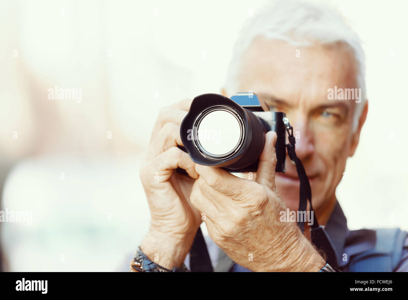 Senior man with camera in city Stock Photo - Alamy