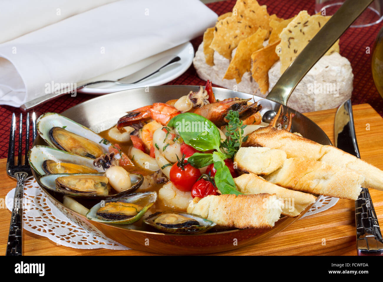 Seafood cocktail, calamari, mussels, shrimp in a pan on the serving ...