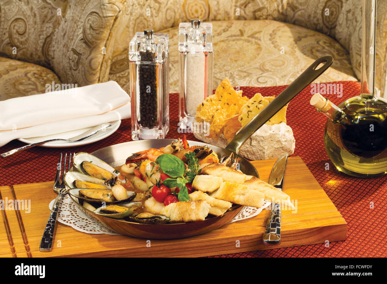 Seafood cocktail, calamari, mussels, shrimp in a pan on the serving ...